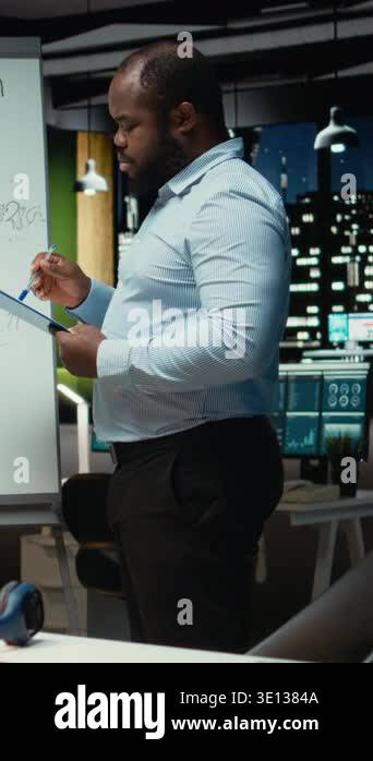 Vertical Video Male advisor drawing candlestick charts on a white board ...