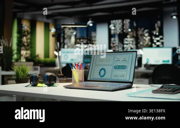 High end empty workspace features laptop with data charts for ...