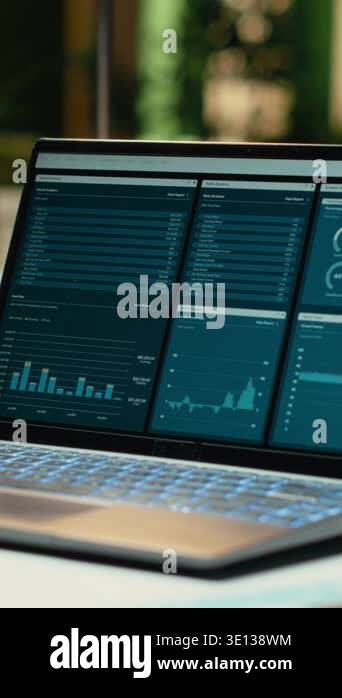 Vertical Video Modern laptop showcasing data reports in an empty office ...