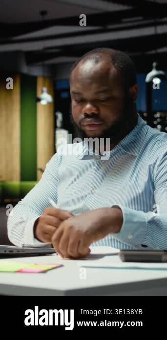 Vertical Video Black guy documenting essential ideas on paper and ...