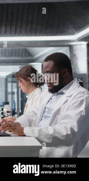 Vertical video Quality control analyst in lab testing blood sample ...