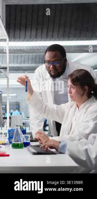 Vertical video Multiethnic chemical engineers using laboratory ...