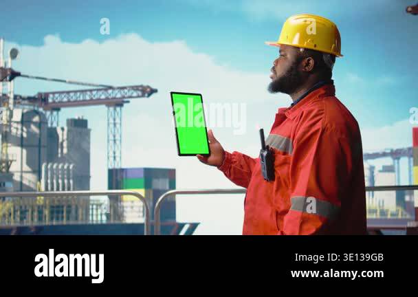 Green screen tablet used by energy production company expert to ...