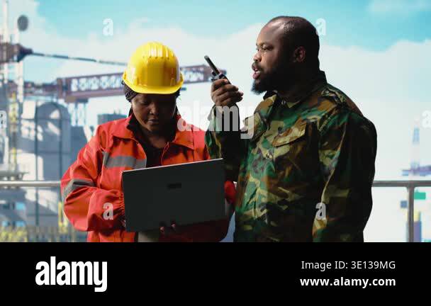 Soldier working on offshore platform issuing command over radio ...