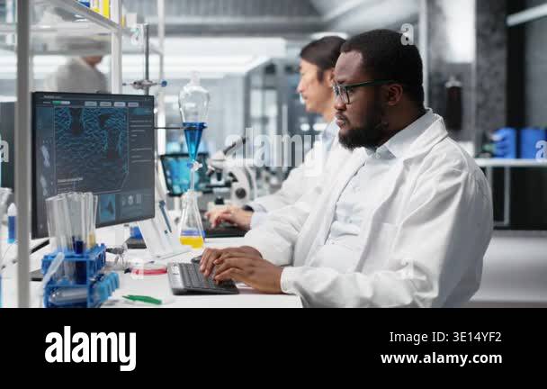 Laboratory bioinformatics scientist evaluates genetic markers using PC ...