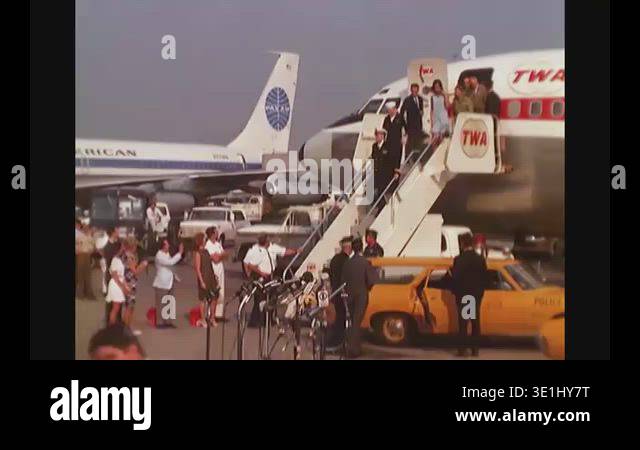 NEW YORK - 1969 - Civilians climb down the airstair of Trans World ...