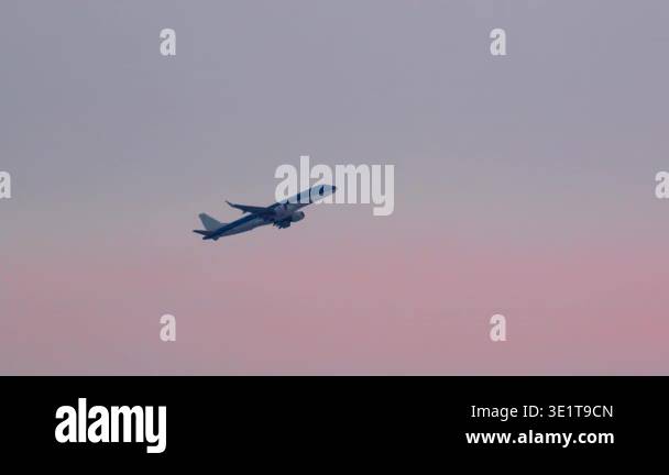 Side view of a blue and white commercial airplane climbing after ...