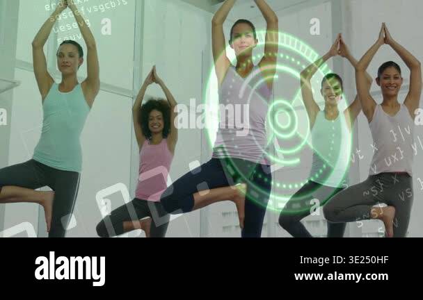 Center woman holding tree pose as group aligning, for balance in yoga ...