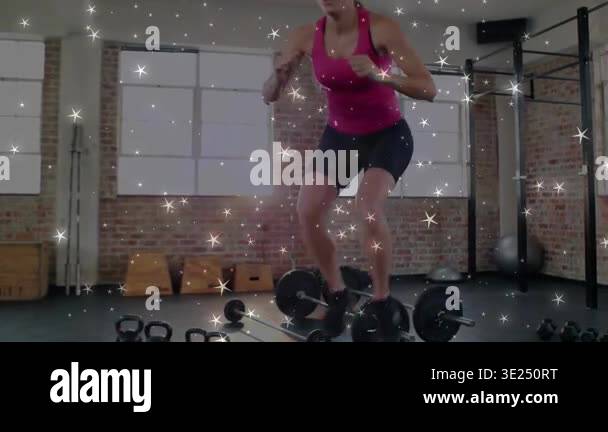 Woman shifting into squat, doing squat jumps for cardio, sparkles ...