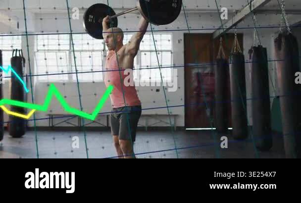 Man shifting stance lowering then rising to stand in overhead squat ...