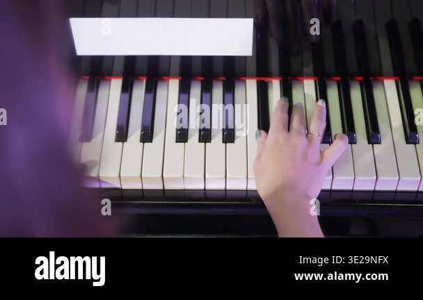 Close-up of female hands playing a piano keyboard, showcasing different ...