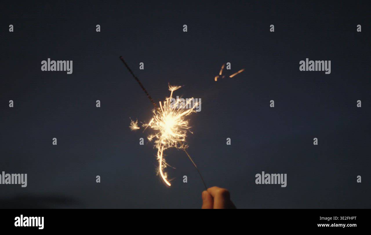 Detail of a festivity sparkler burning in hand Stock Video Footage - Alamy