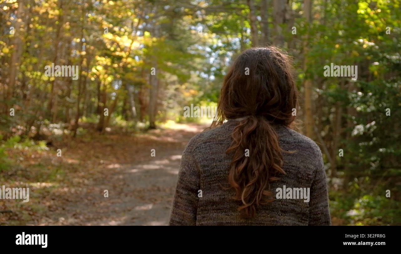 Behind woman walking in park Stock Video Footage - Alamy