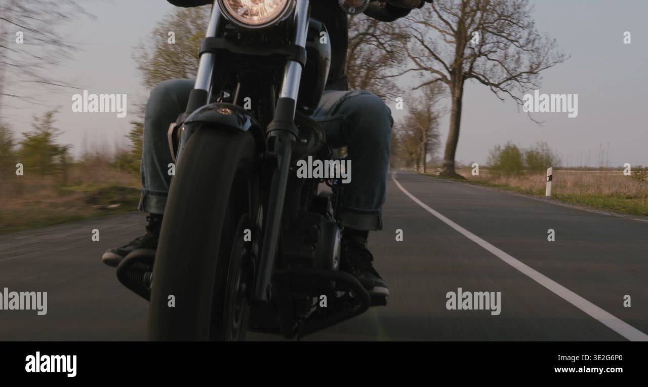 Biker driving motorcycle on rural road Stock Video Footage - Alamy