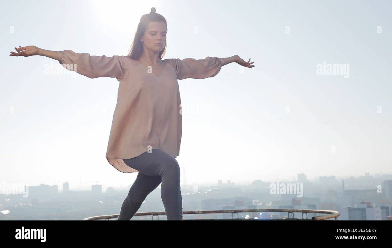 Girl standing in yoga asana on city roofs background Stock Video ...