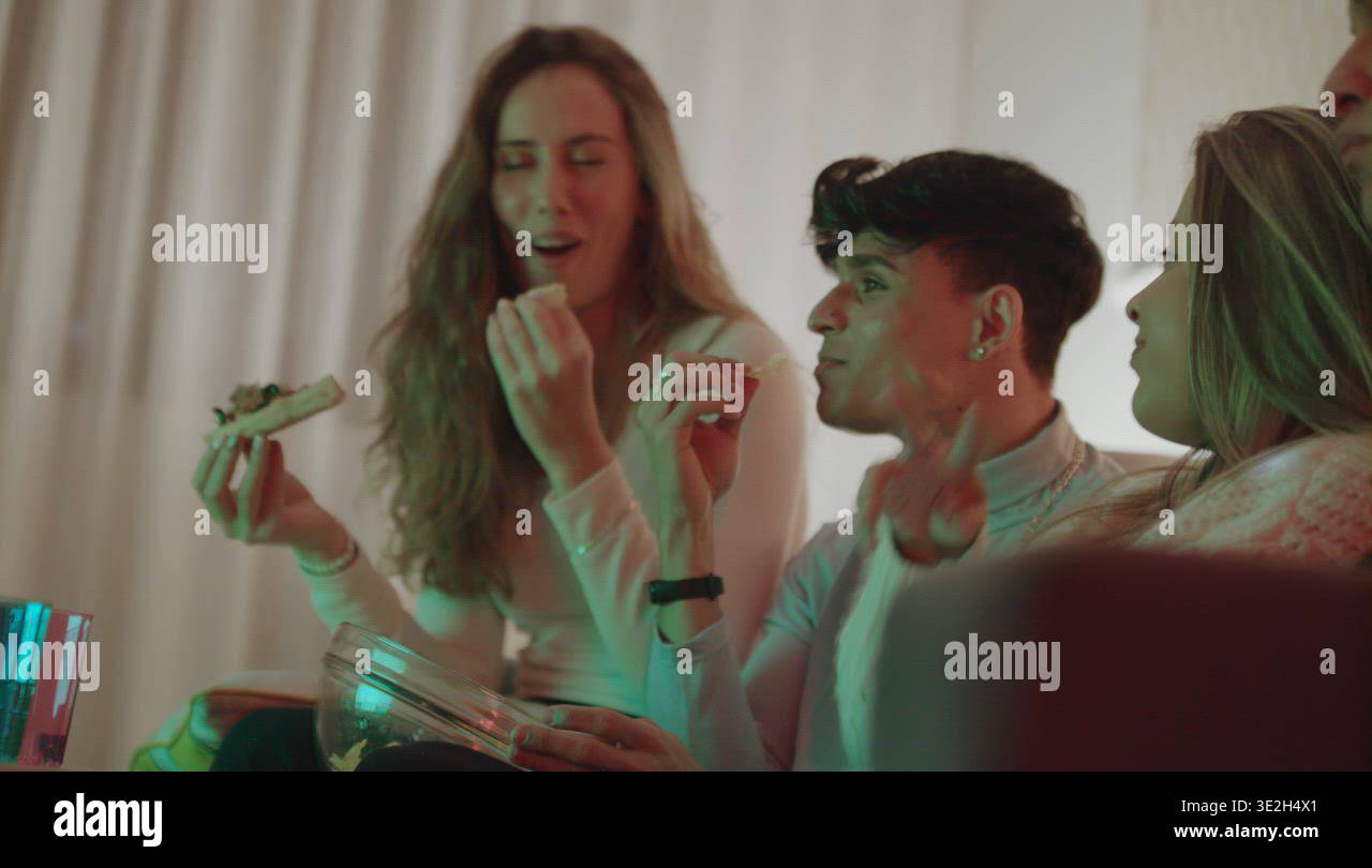 Guy offering snacks to talking friends during party Stock Video Footage ...