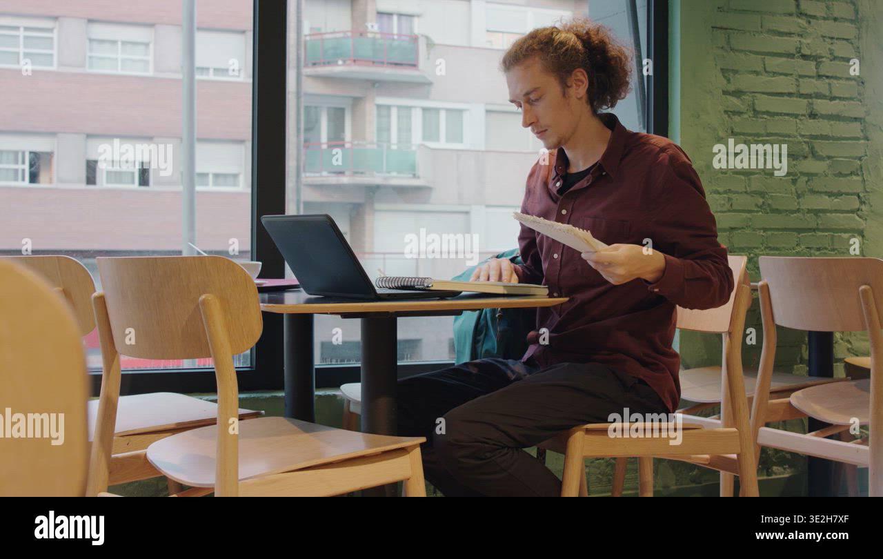 Adult man reading notes in cafe Stock Video Footage - Alamy
