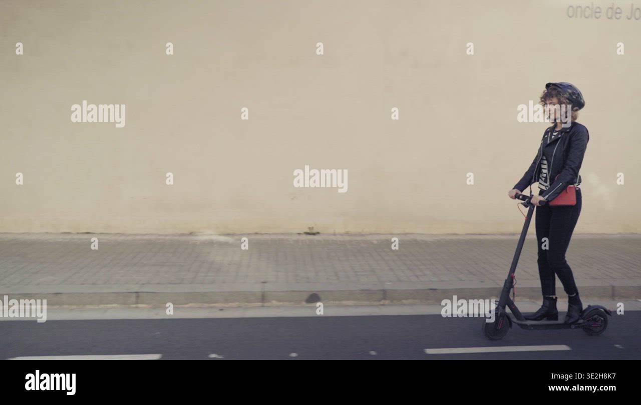 Adult lady riding electric scooter outside shabby building Stock Video ...