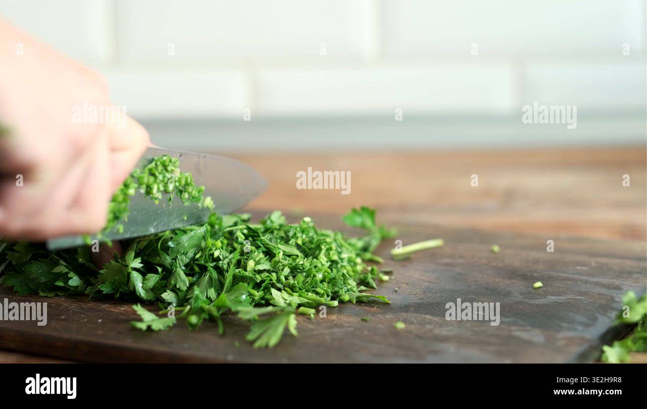 Person chopping up parsley on cutting board in kitchen Stock Video ...