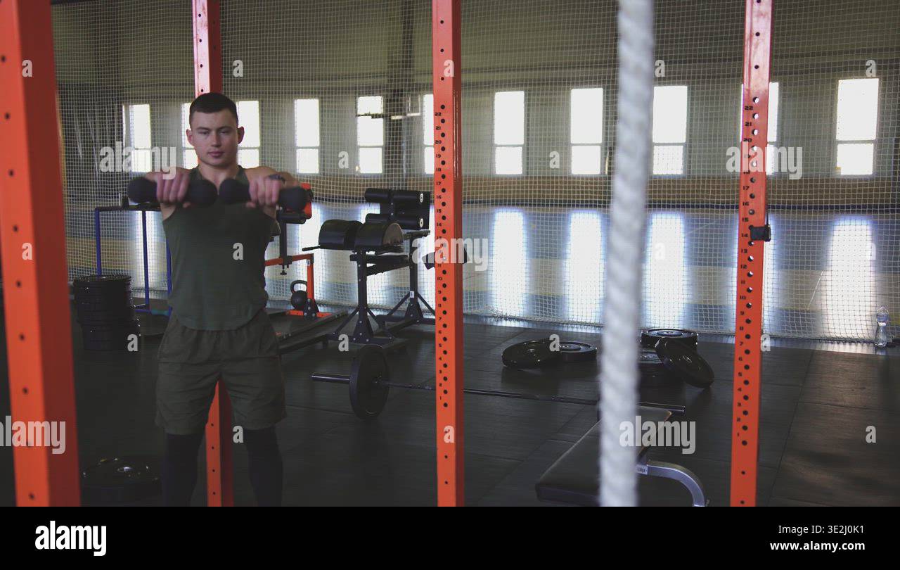Strong building up muscles with dumbbells Stock Video Footage - Alamy