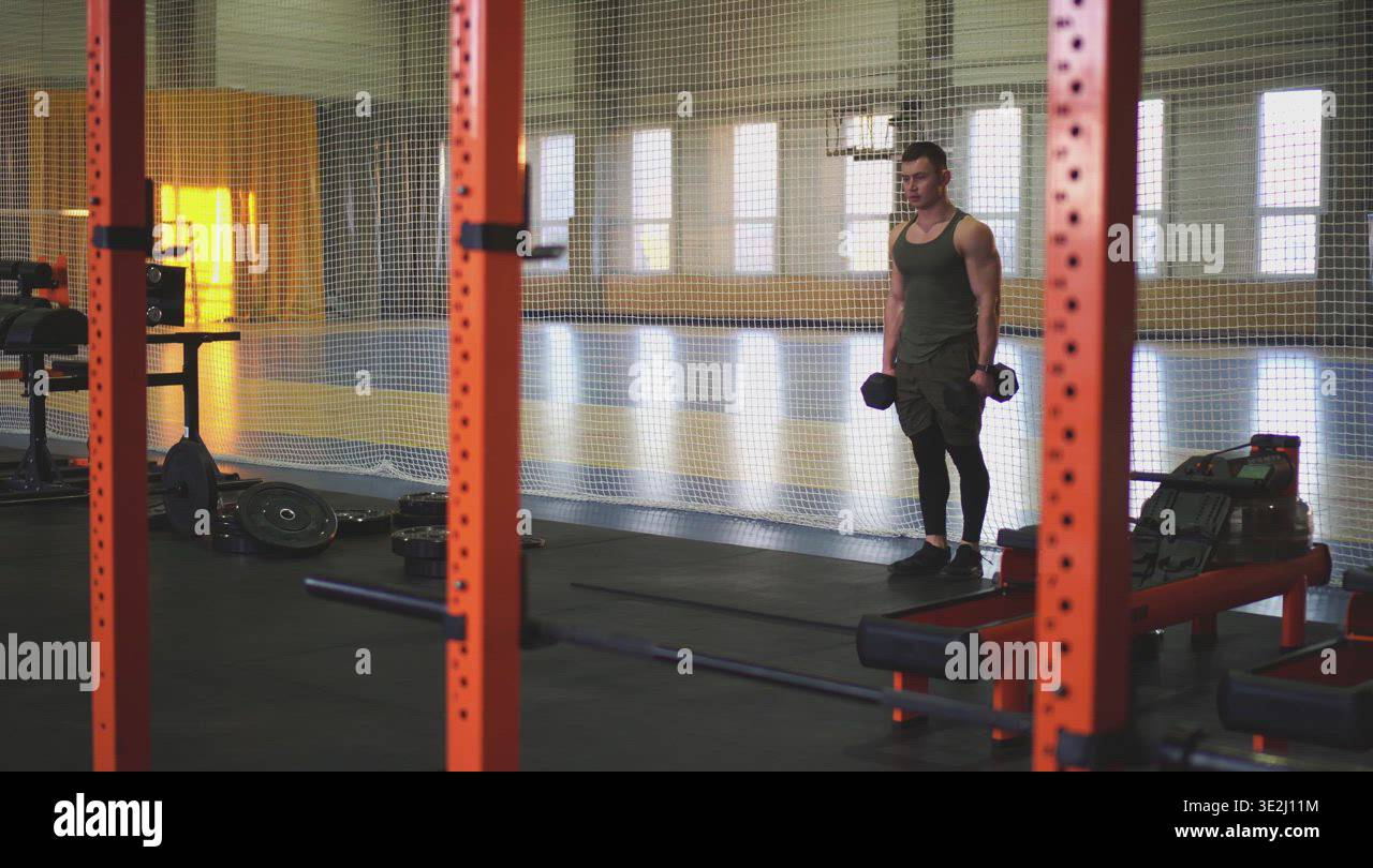 Man shaping up his body and lifting weights Stock Video Footage - Alamy