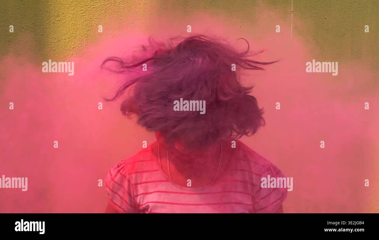 Slow motion video of moving hair with color powder in it to and fro ...