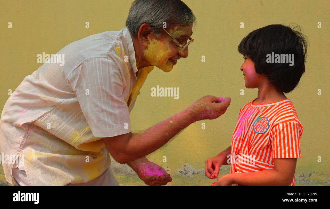Aged man playing holi with grandchildren Stock Video Footage - Alamy