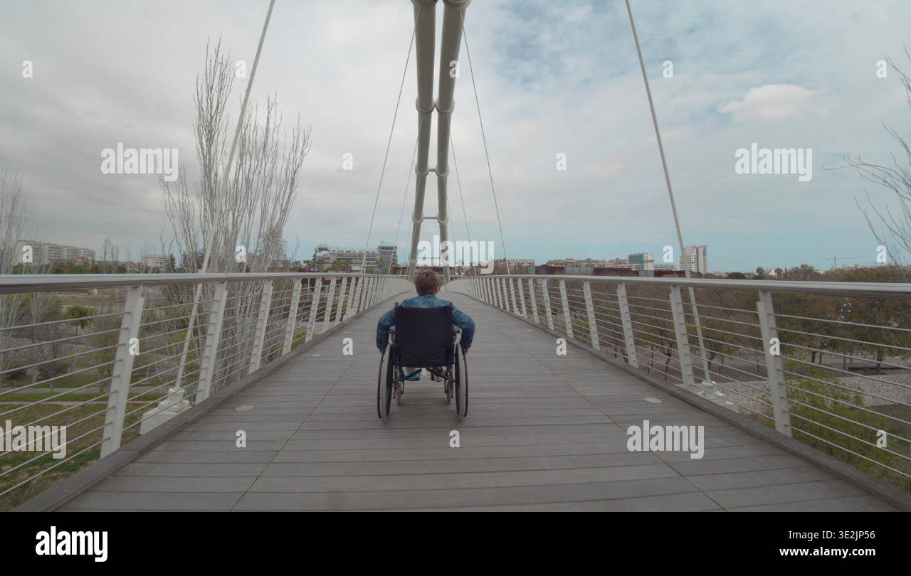 Injured child in wheelchair taking an outing alone Stock Video Footage ...