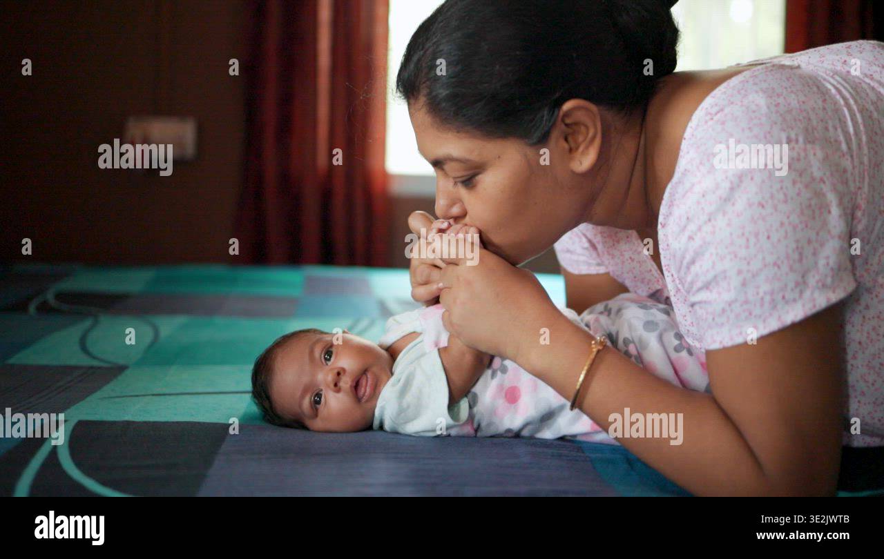 Mother spending affectionate time with her new born baby girl Stock ...