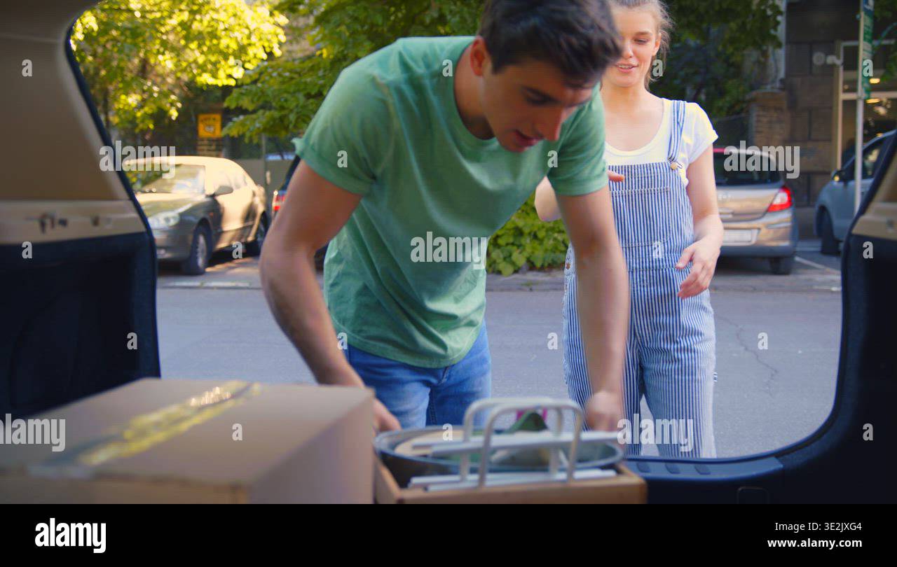 Man and Woman Taking Things Out of Trunk Stock Video Footage - Alamy