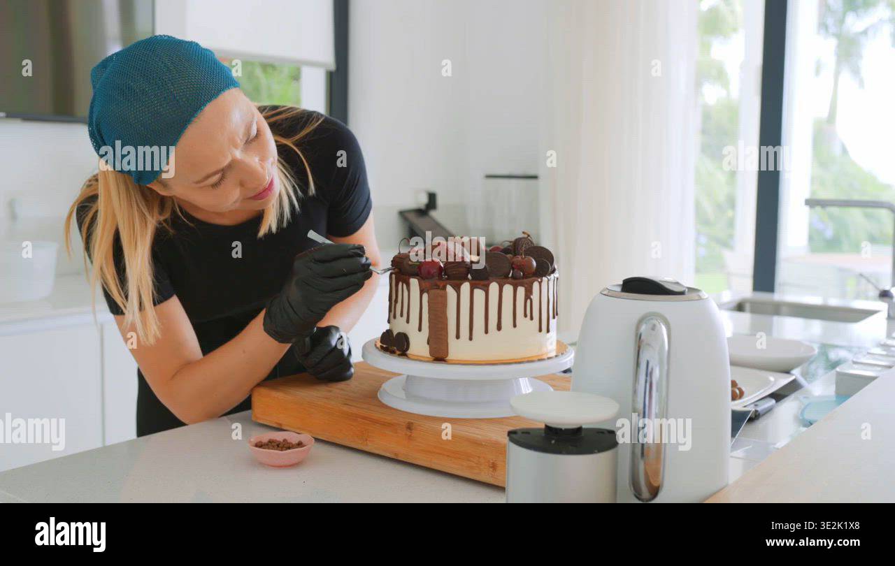 Woman decorating a cake with tweezers Stock Video Footage - Alamy