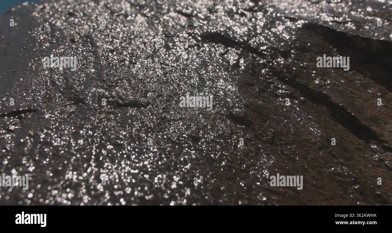 Glittering wet rock wall with blue sky Stock Video Footage - Alamy