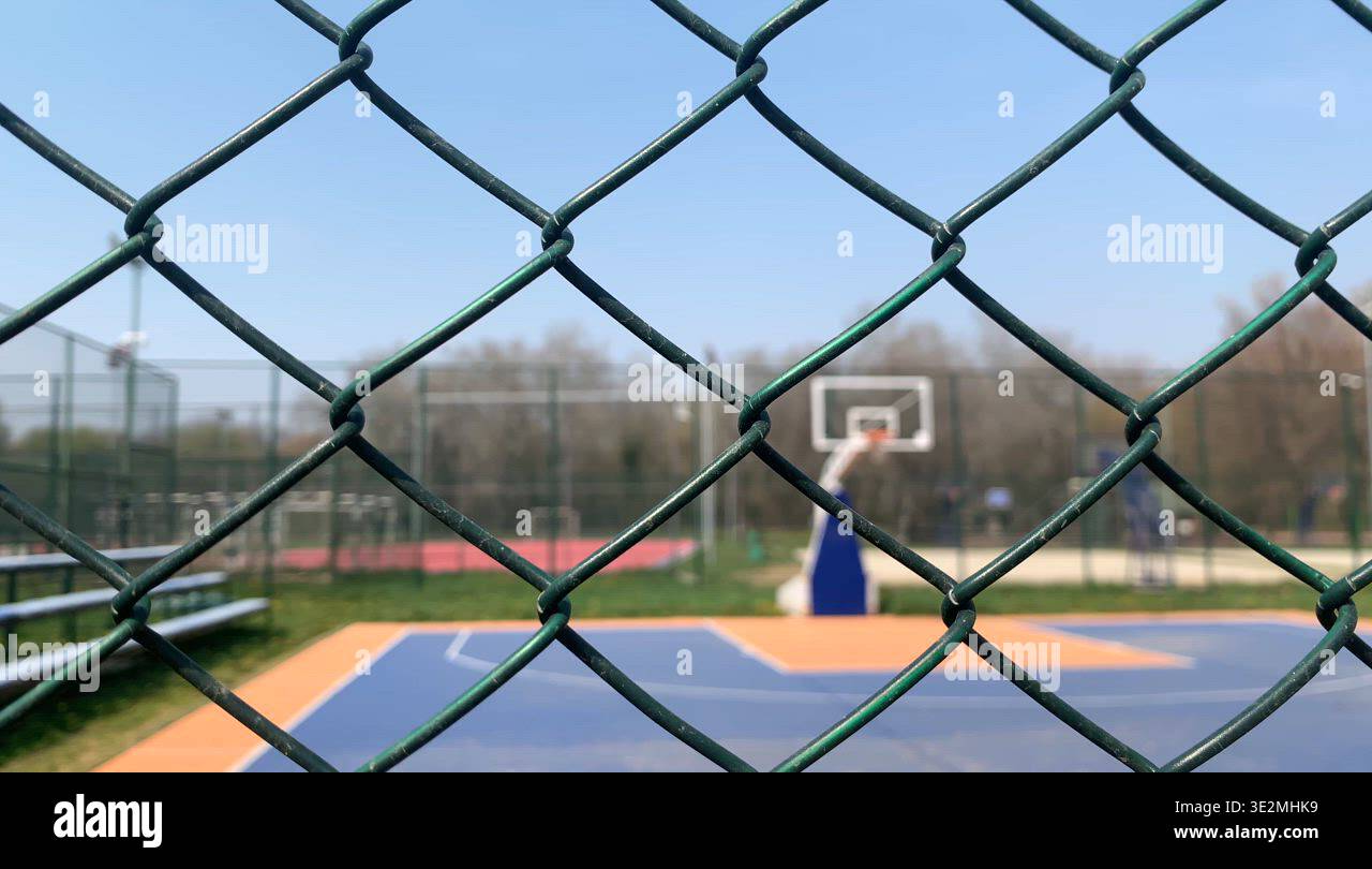 basketball court and blue sky behind the green net fence Stock Video ...