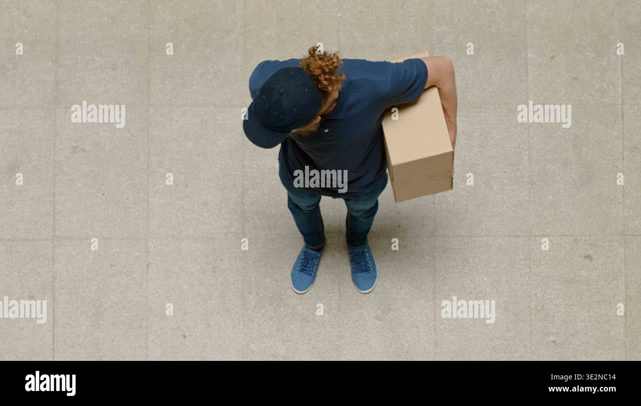 Delivery man using smartphone on street Stock Video Footage - Alamy