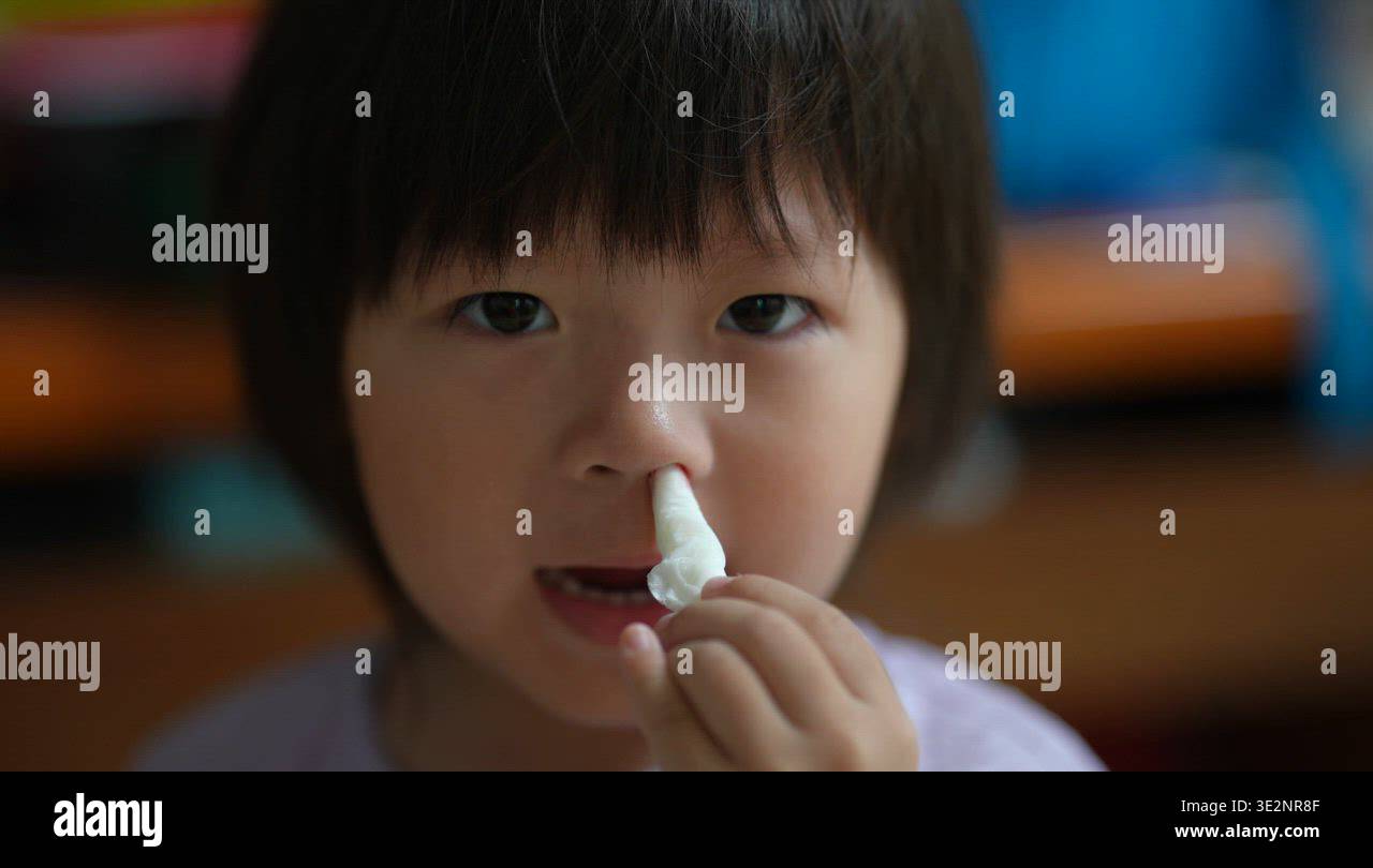 Child uses tissue to stop nosebleed Stock Video Footage - Alamy