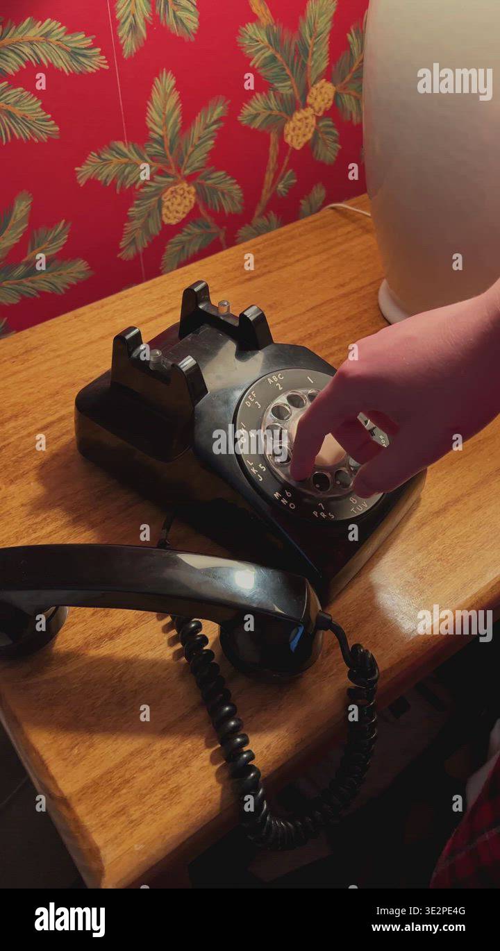 Vintage black Rotary Dial being dialed Telephone and funky wallpaper ...