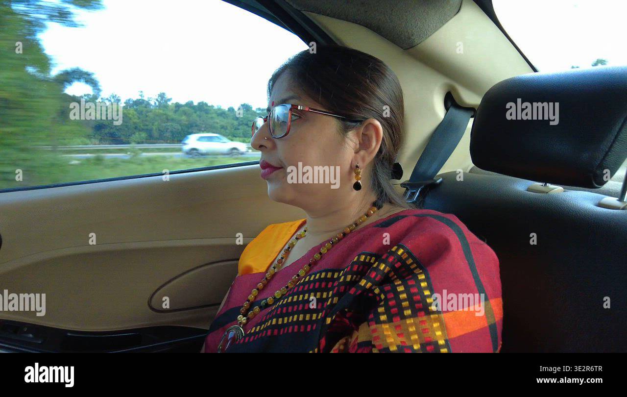 fashionable Indian woman wearing traditional dress and travel in car ...