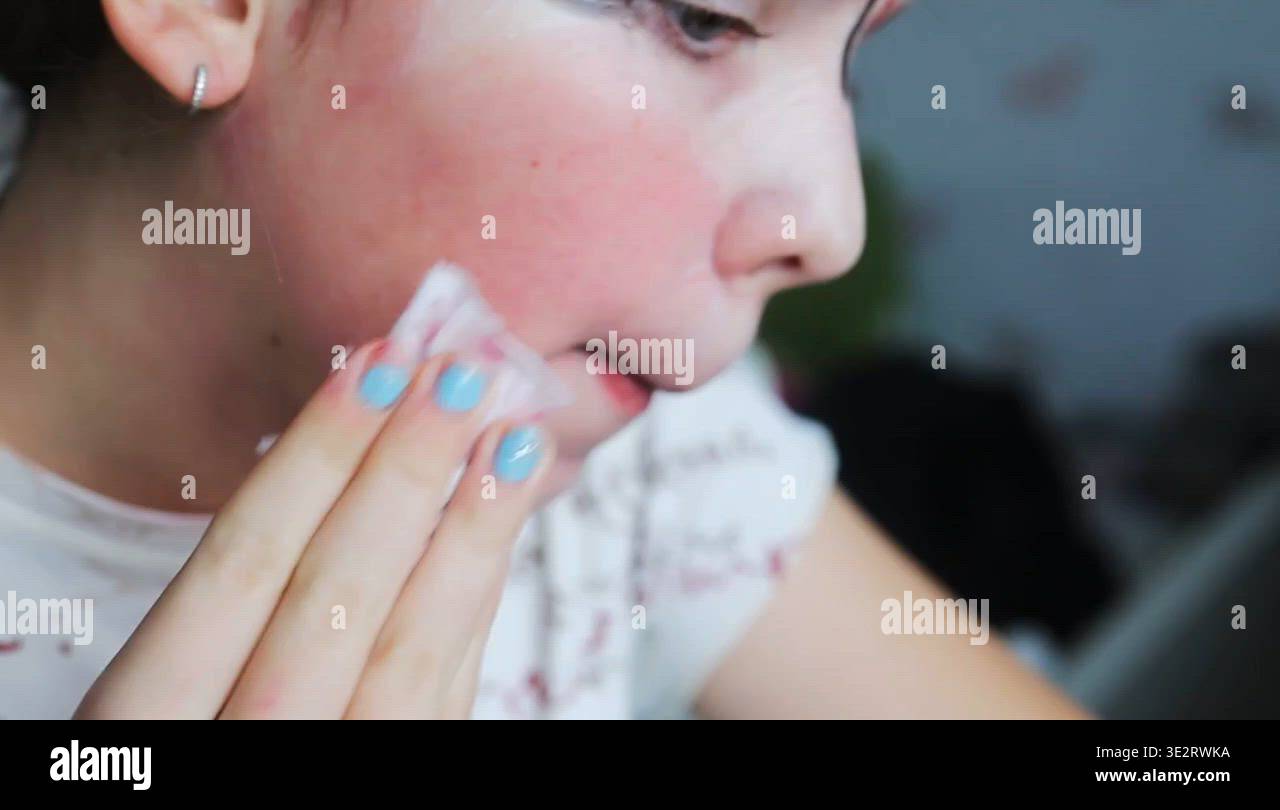 the girl erases the paint on her face Stock Video Footage - Alamy