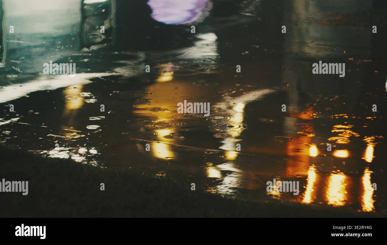 Rain Drops Falling Into A Puddle Stock Video Footage - Alamy