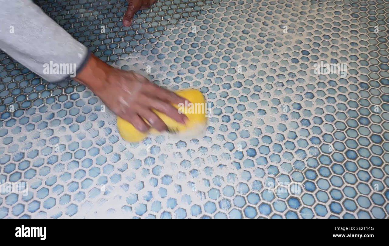Professional Hand sponge install Residential tiling floor white grout ...