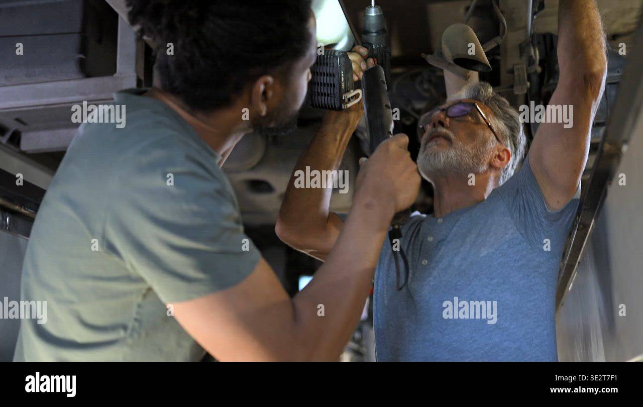 Coworkers repairing motor vehicle at garage Stock Video Footage - Alamy