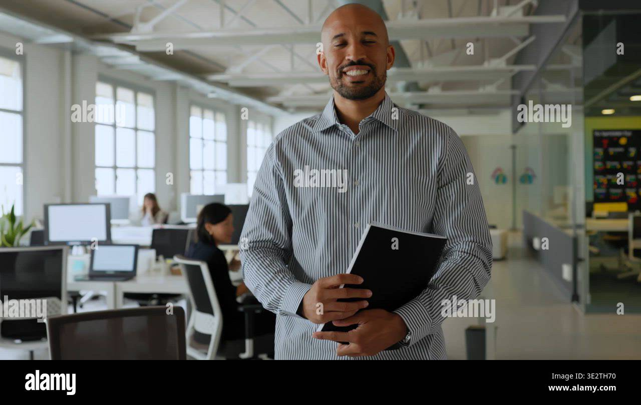 Confident business manager smiling with arms crossed in office Stock ...
