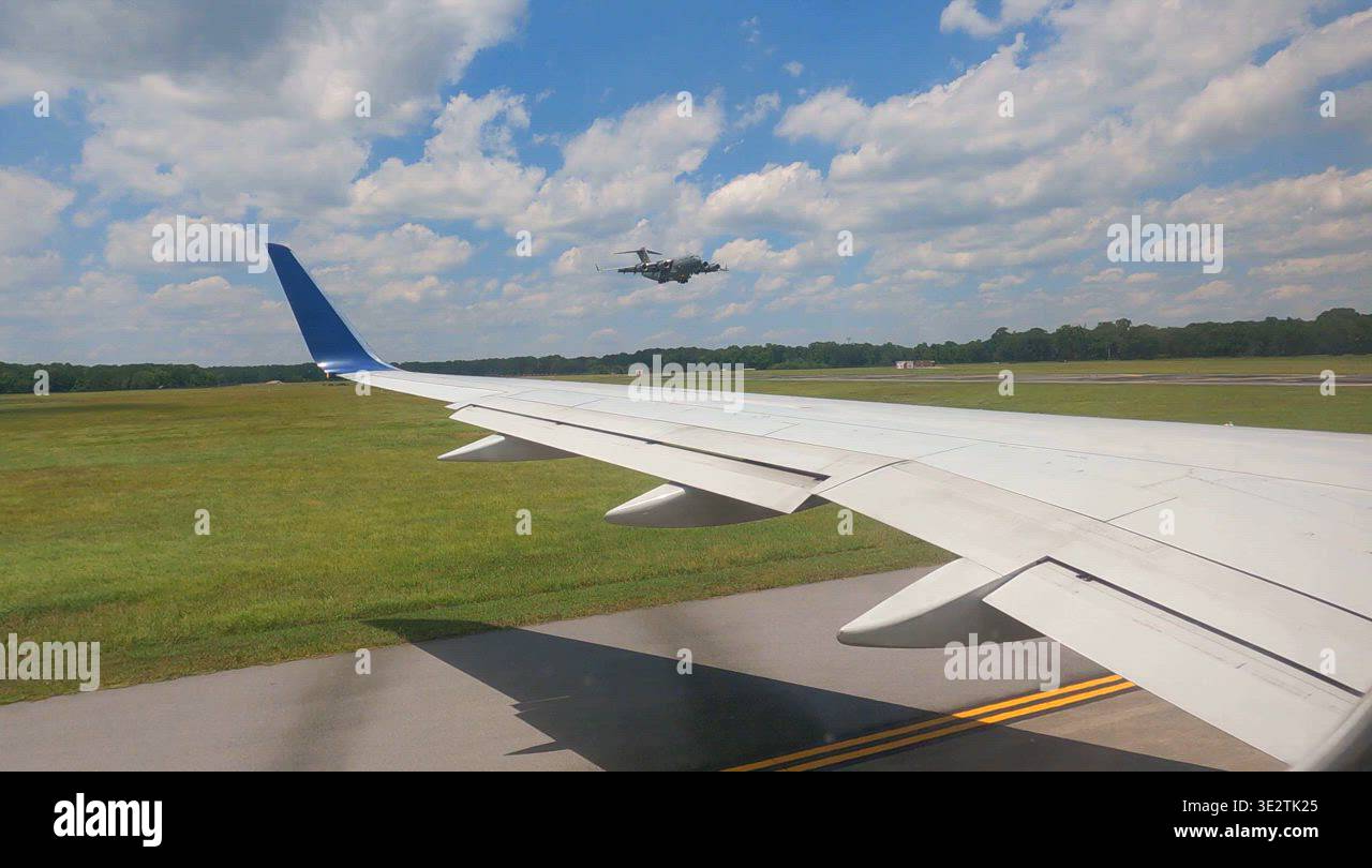 Military plane landing on airport runway Stock Video Footage - Alamy