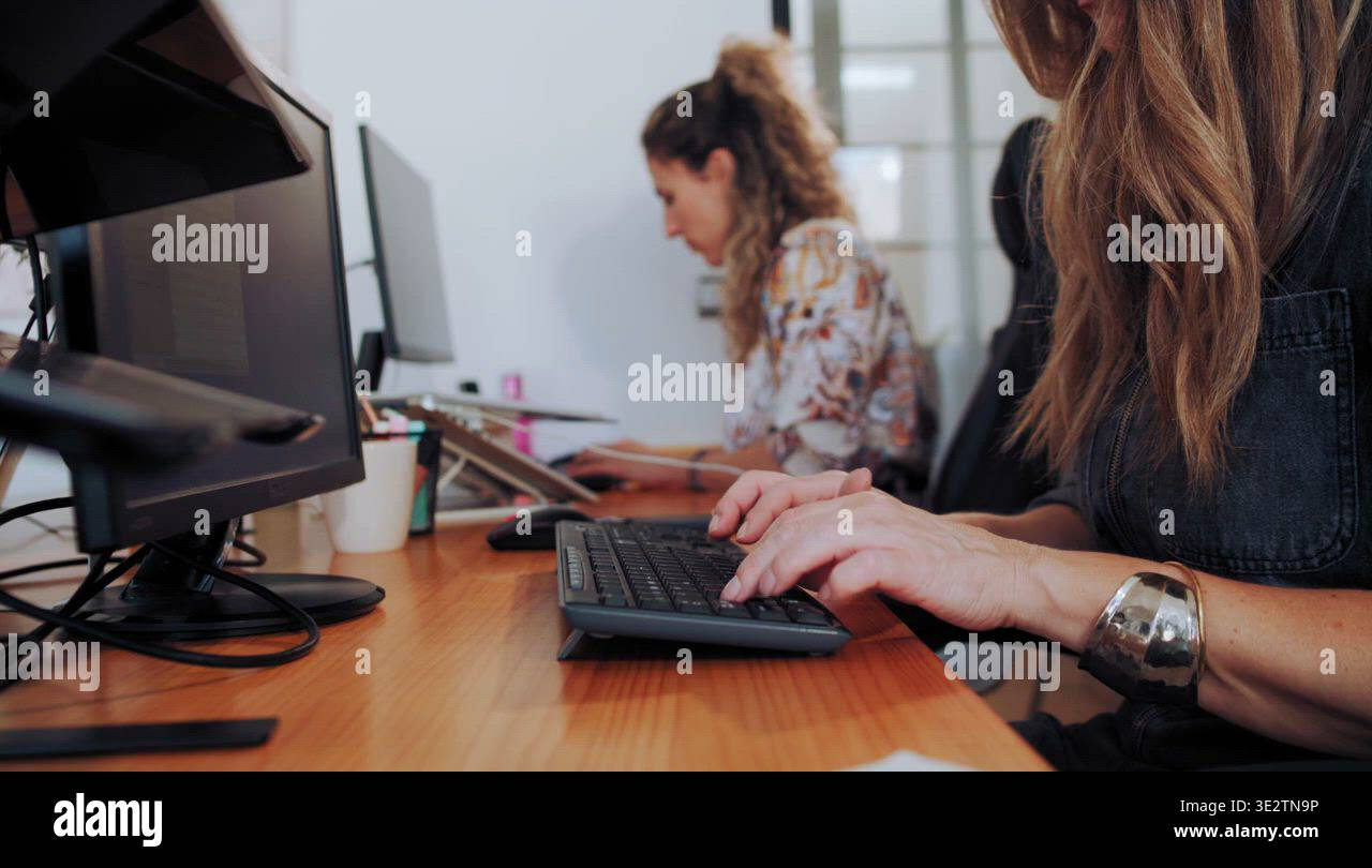 Women typing on computer keyboard Stock Video Footage - Alamy