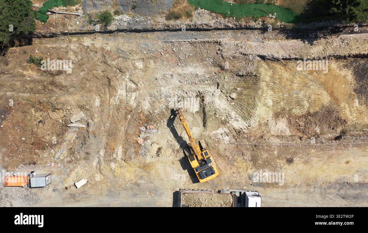 An excavator loading excavation onto a truck at a construction site ...