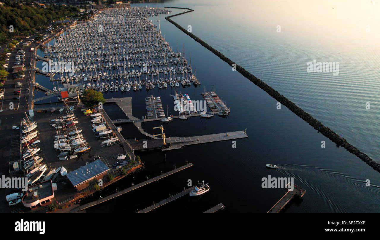 Sunset Aerial of Boat Pulling into Ocean Marina Stock Video Footage - Alamy