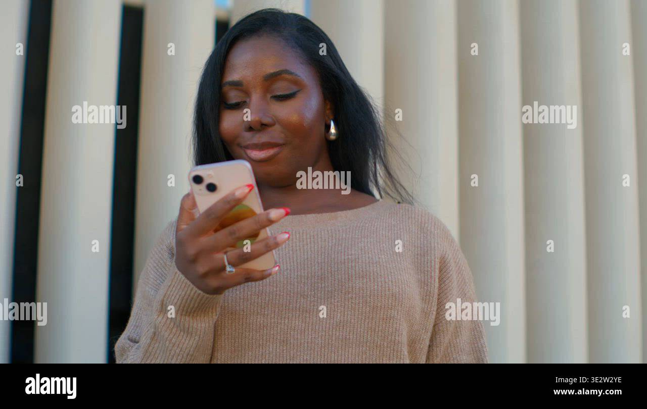a woman with a wry smile texting with one hand Stock Video Footage - Alamy