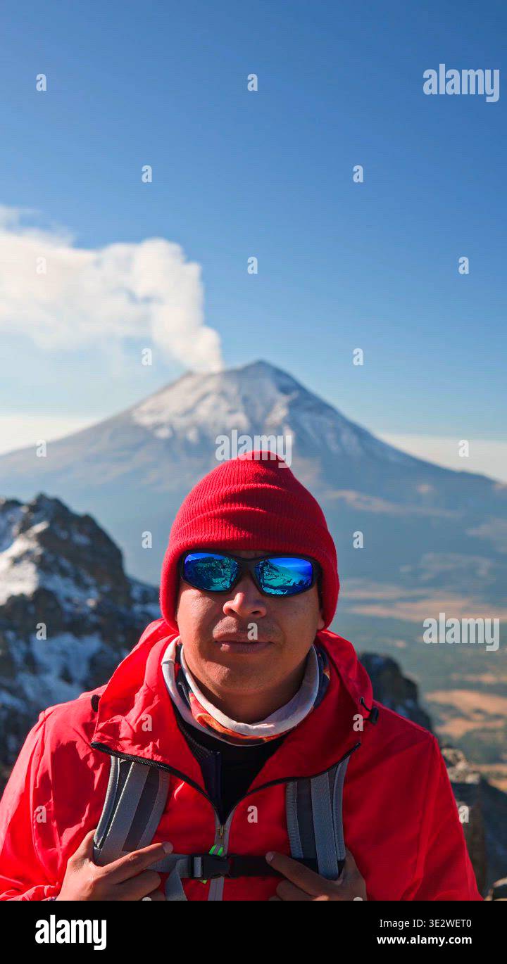 Mountaineer wearing sunglasses hiking near smoking volcano Stock Video ...