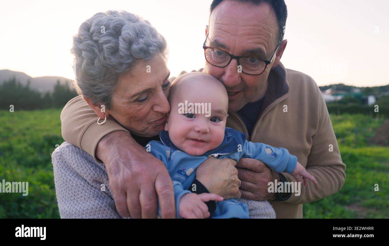 grandparents hugging their grandchild Stock Video Footage - Alamy
