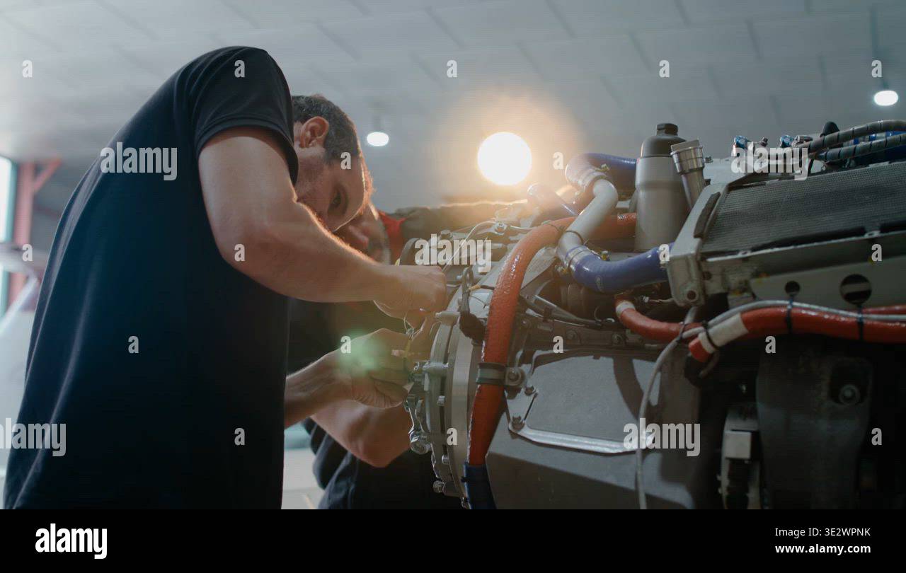 Professional mechanics servicing aircraft engine Stock Video Footage ...